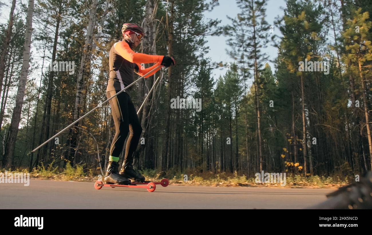 Training an athlete on the roller skaters. Biathlon ride on the roller ...