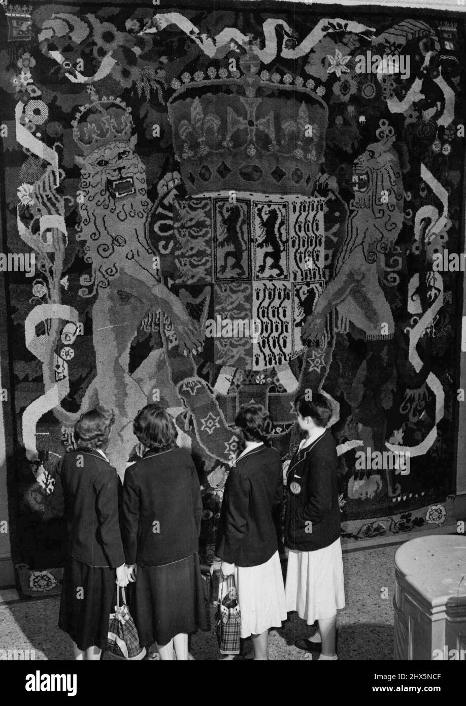 A group of schoolgirls admire the carpet made in prison by an "old lag ...