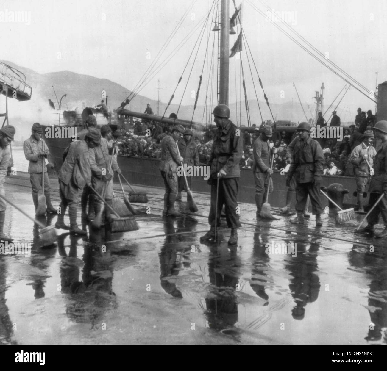 Japs Sweep Down Dock -- Japanese Soldiers in Korea sweep down a dock in ...
