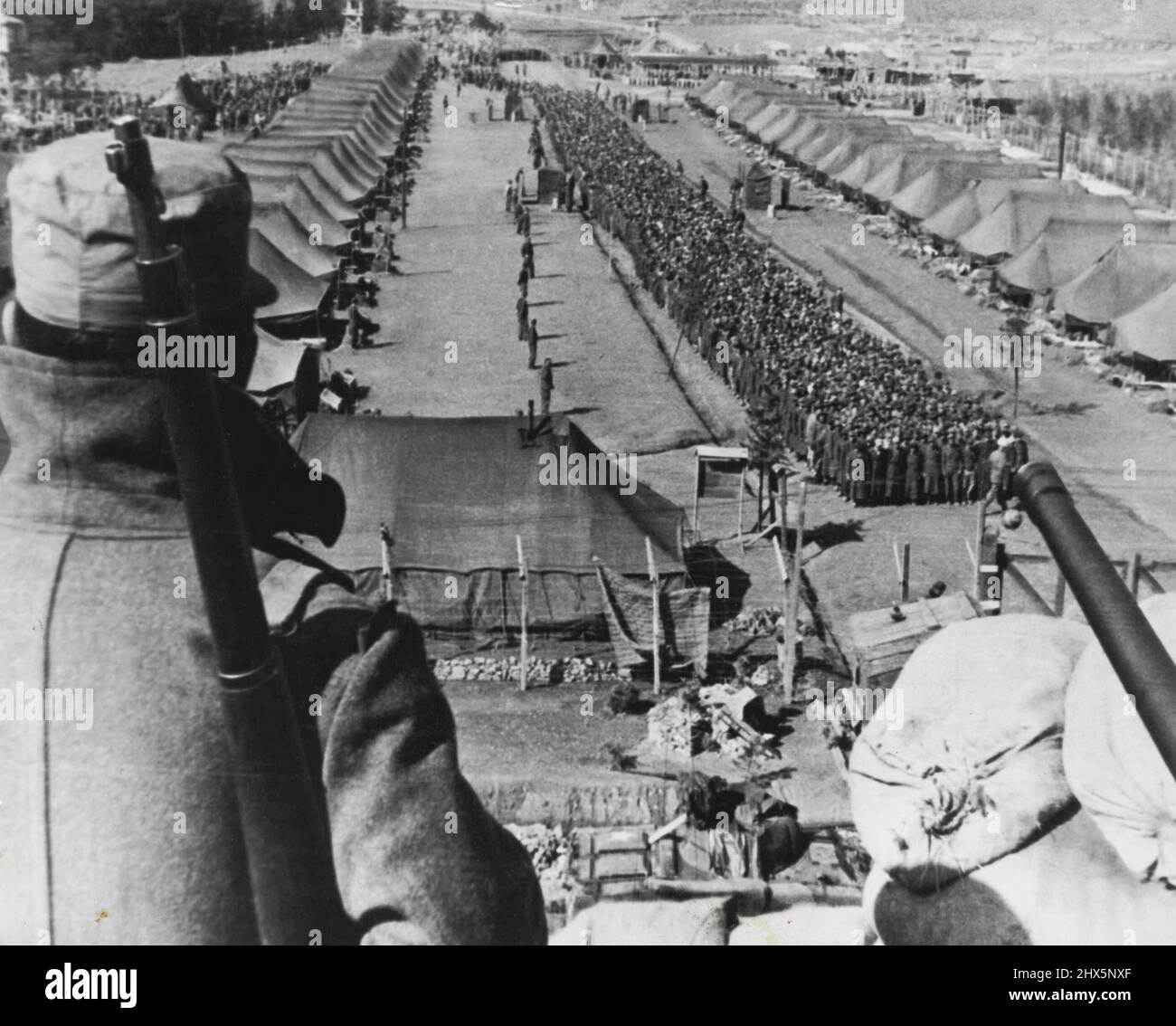 A United Nations soldier (left) guards Communist prisoners-of-war of a ...