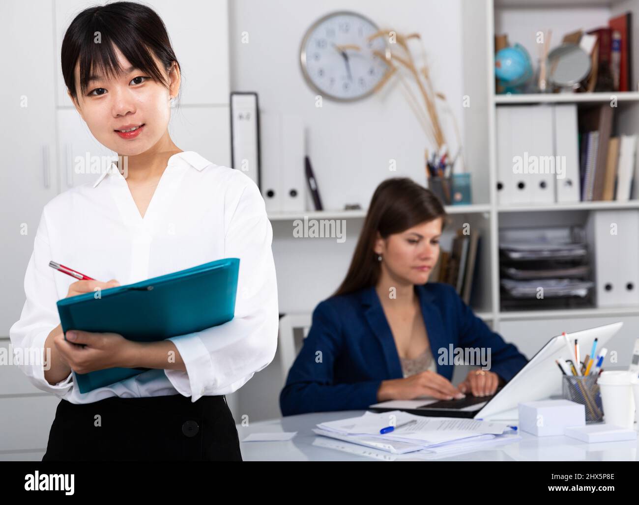 Portrait of successful confident chinese business woman in office ...