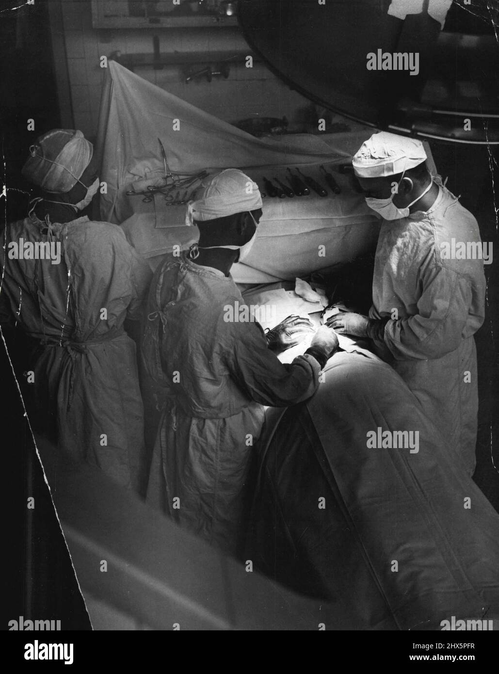 Men In White -- Here is an actual bone operation in progress. Pieces of ...