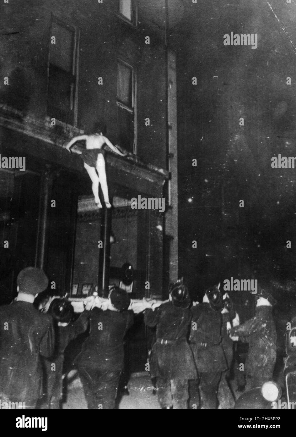 Woman Leaps Into Firemen's Net From Third-Story Ledge -- Firemen get a ...