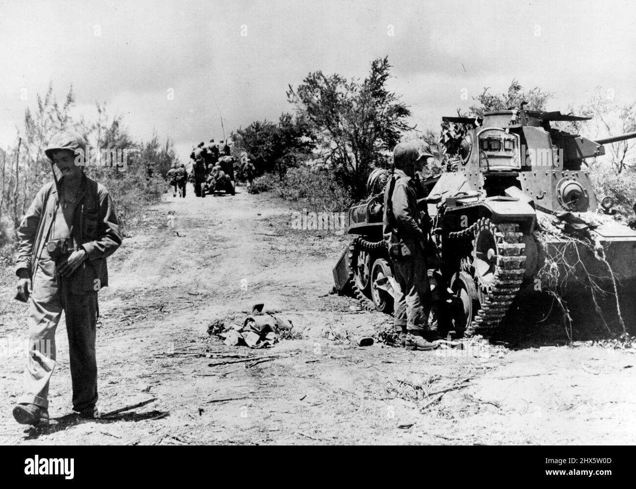 Double Trouble -- A Marine half-track, mounting a 74 mm gun and towing ...