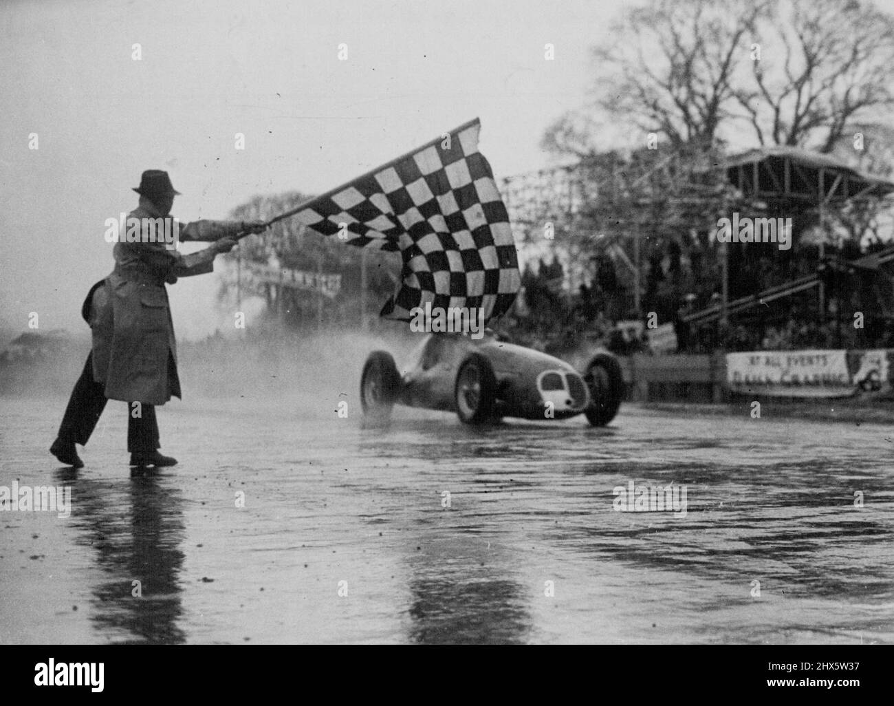 Reg Parnell, 38-year-old British racing driver, flashing by the winning ...