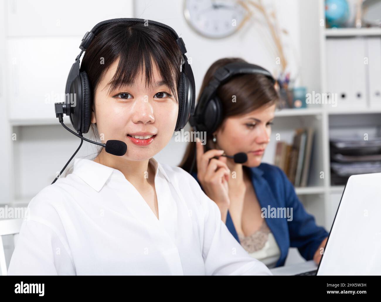 Operators working with computers in an office Stock Photo - Alamy