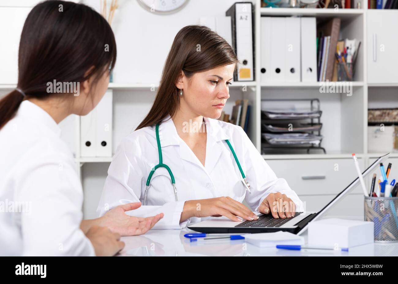Female doctor consulting patient Stock Photo - Alamy