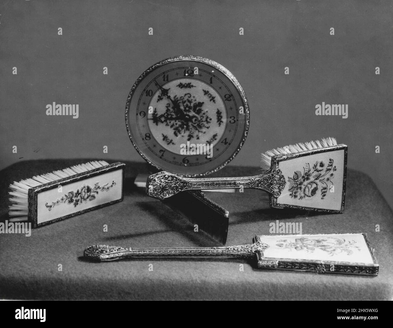 Petit Point work in soft colors, and gold filigree, decorate this ...