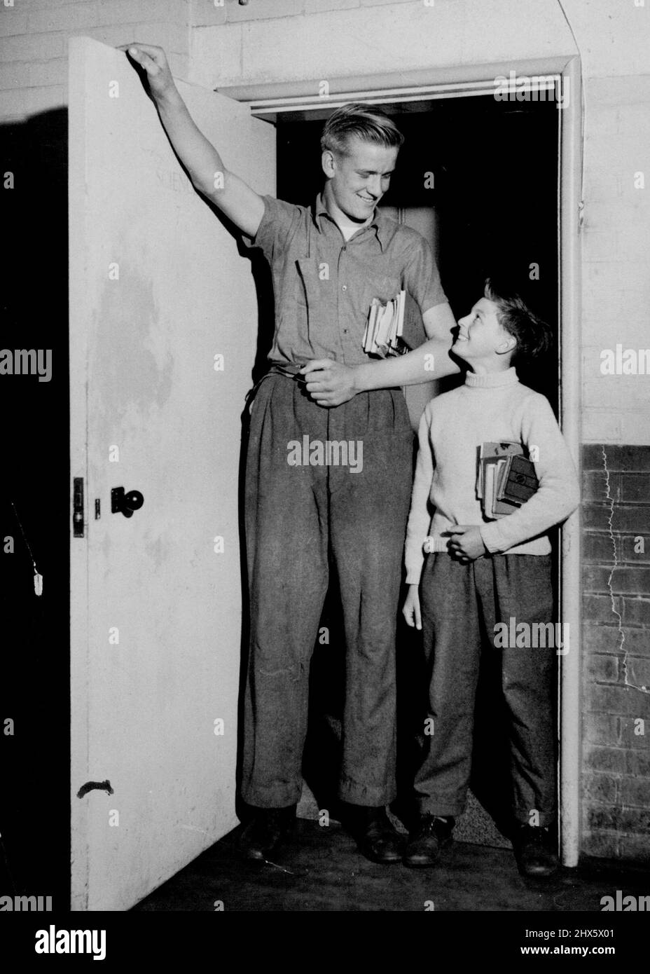 Fourteen year old John Parker (6ft. 7in. tall) "heads" the door of his ...