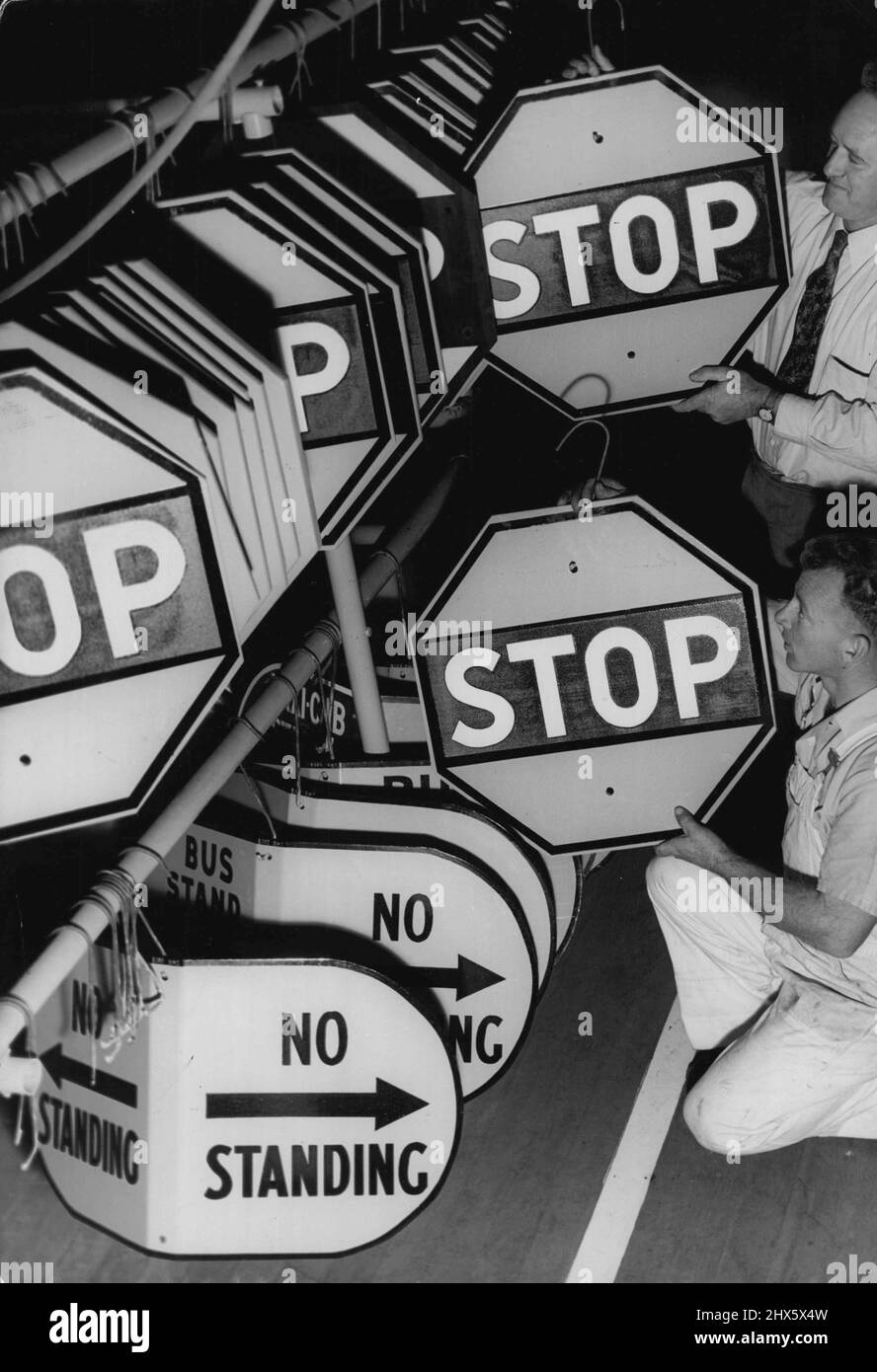 Department of Motor Transport officials completing the new stop signs ...