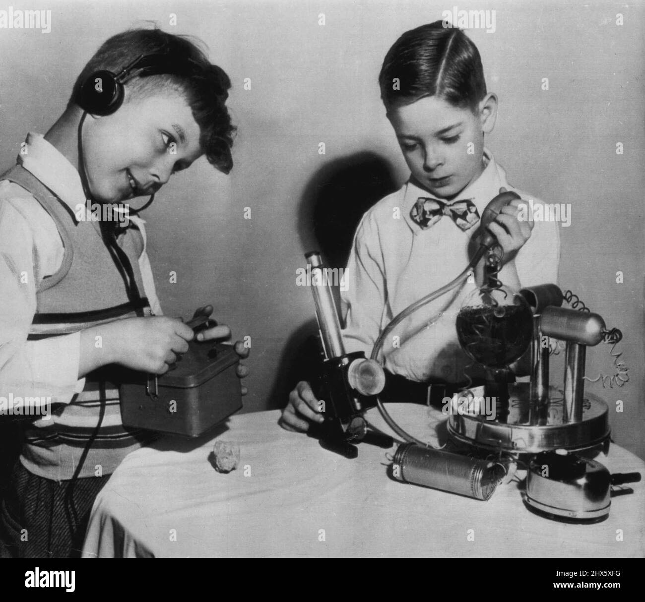 Atomic Toys -- Stefan Olsen (left), 8, and Bobby Miller, 7, examine a ...