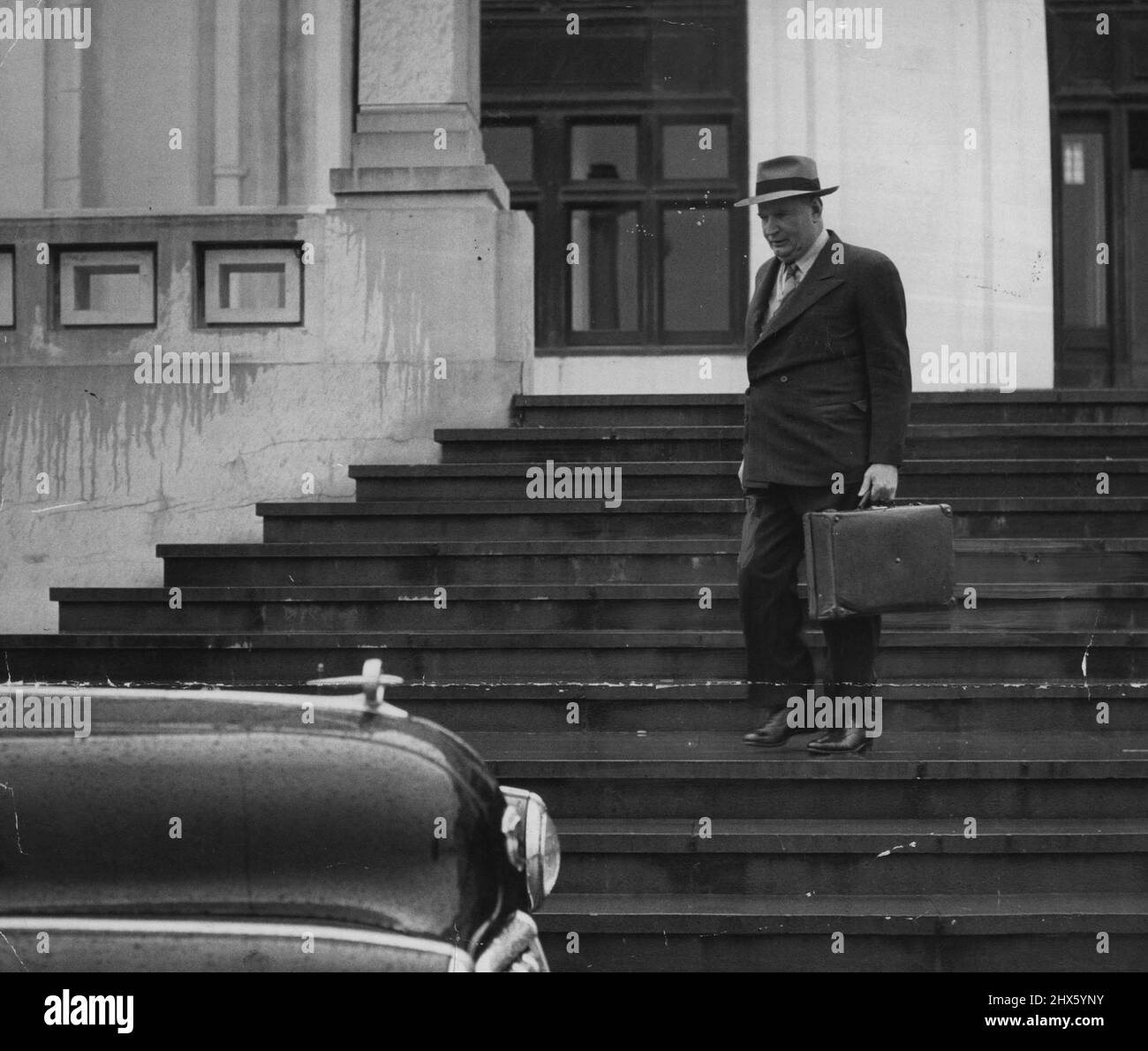 Thoughtful Treasurer....Sir Arthur Fadden walks down the steps outside ...