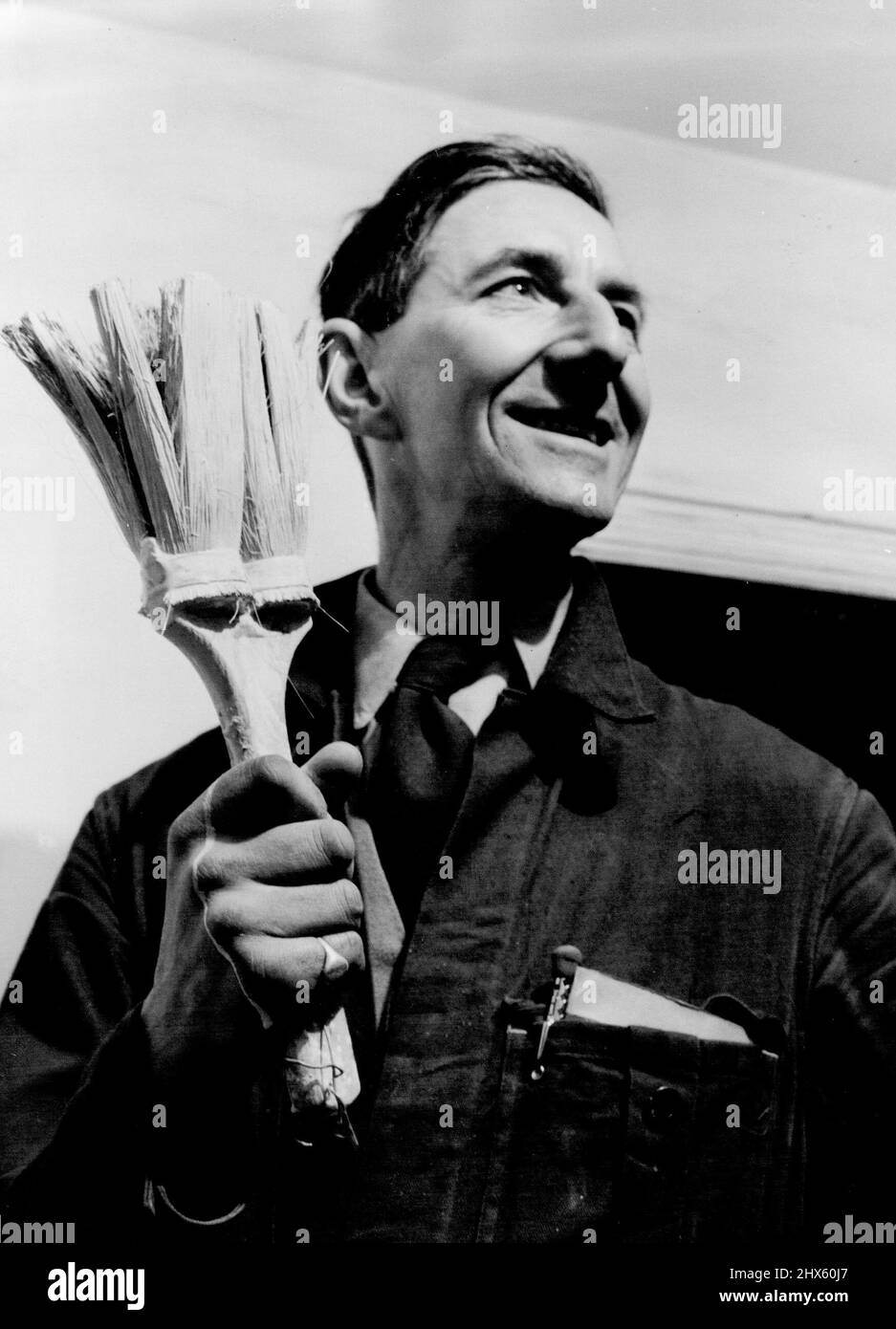 Sir Richard Acland preparing to whitewash the roof of his new ...