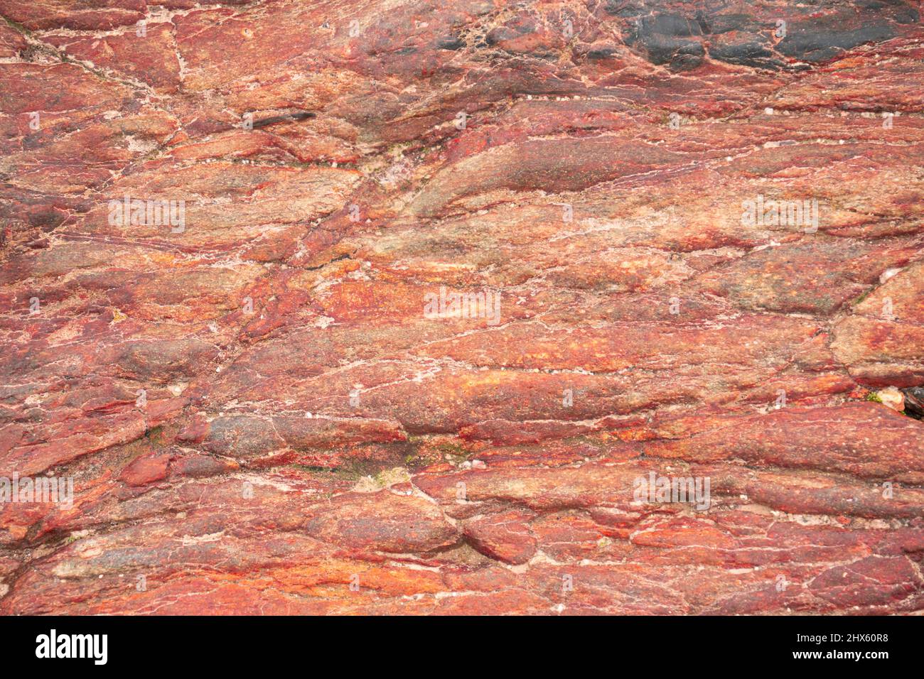 Natural red rusty granite rock wall background Stock Photo - Alamy