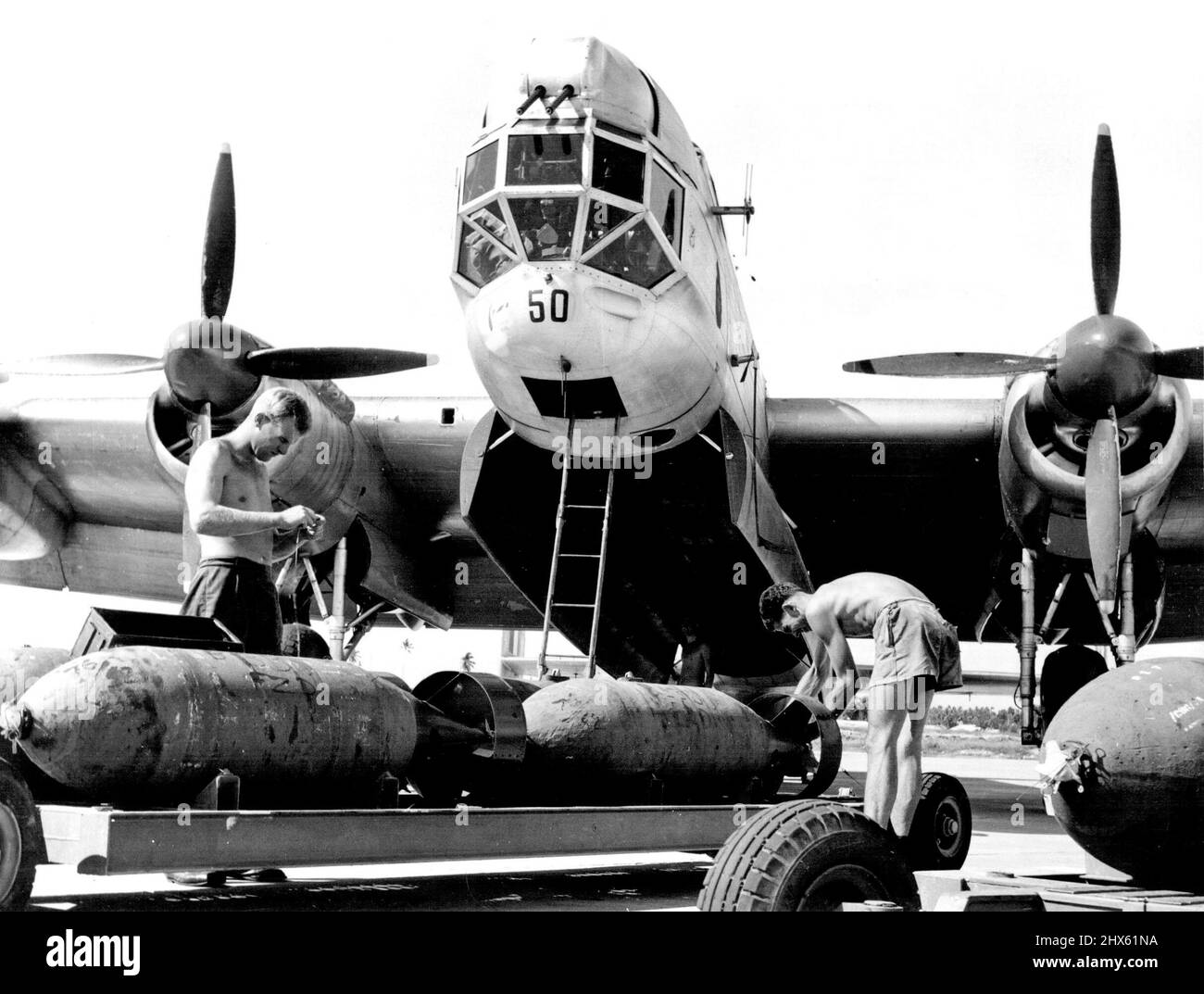 Above: Bombs being loaded on to a four-engined Lincoln bomber of No. 1 ...