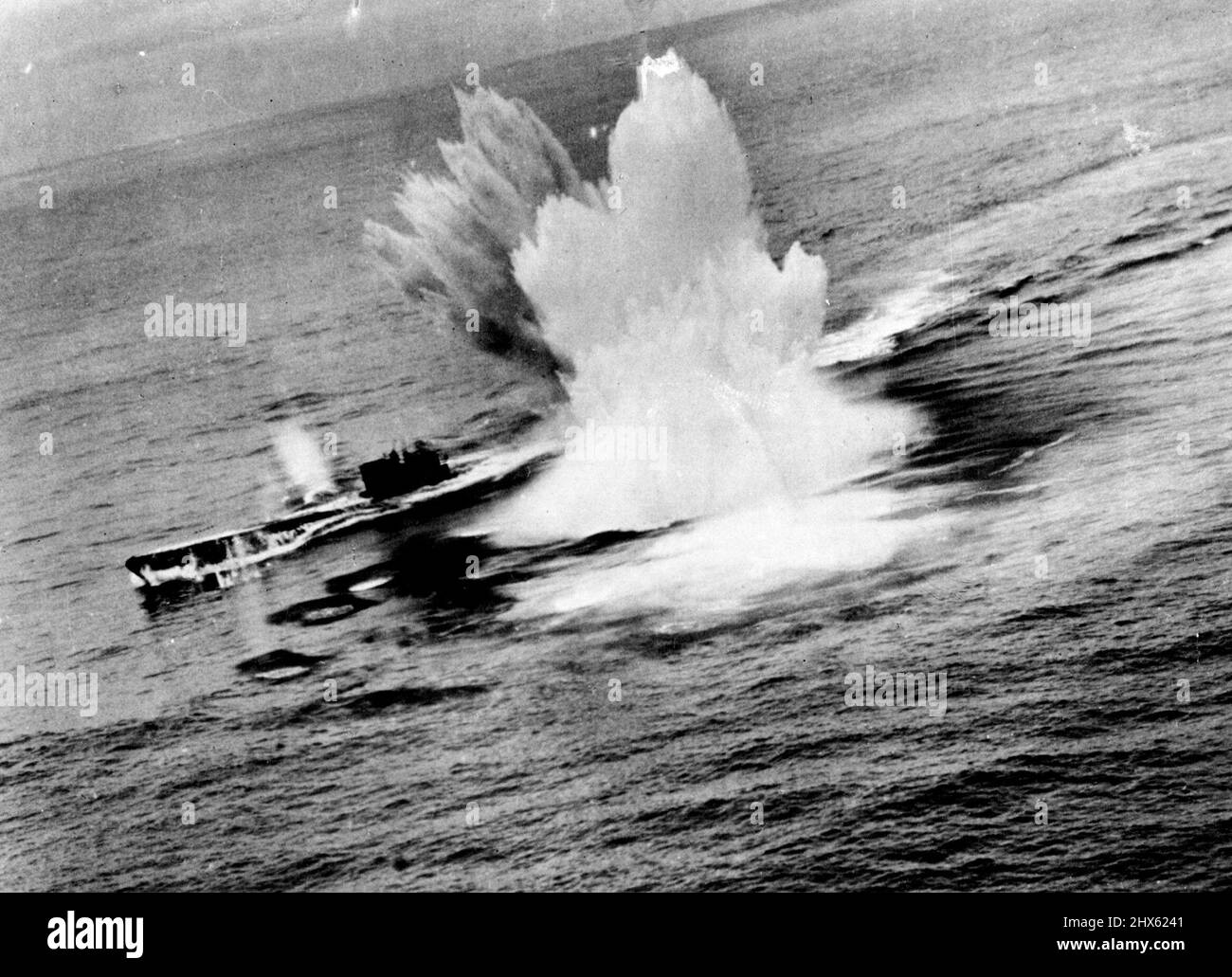 The first two depth charges dropped explode around the stern of the U ...