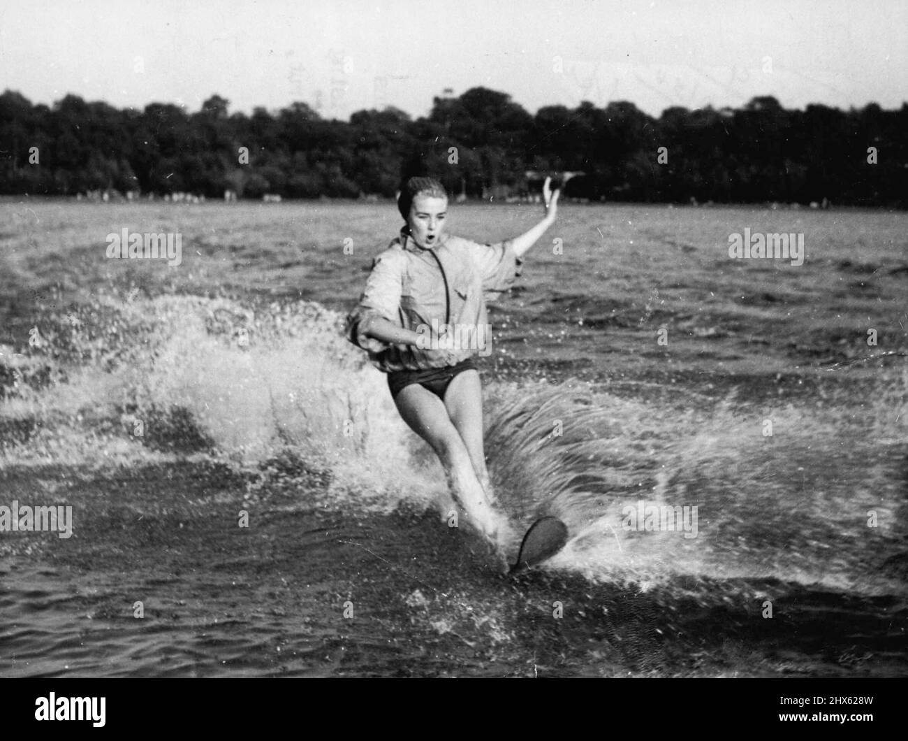 Over the 'waves', with no visible means of support, goes water-skier ...