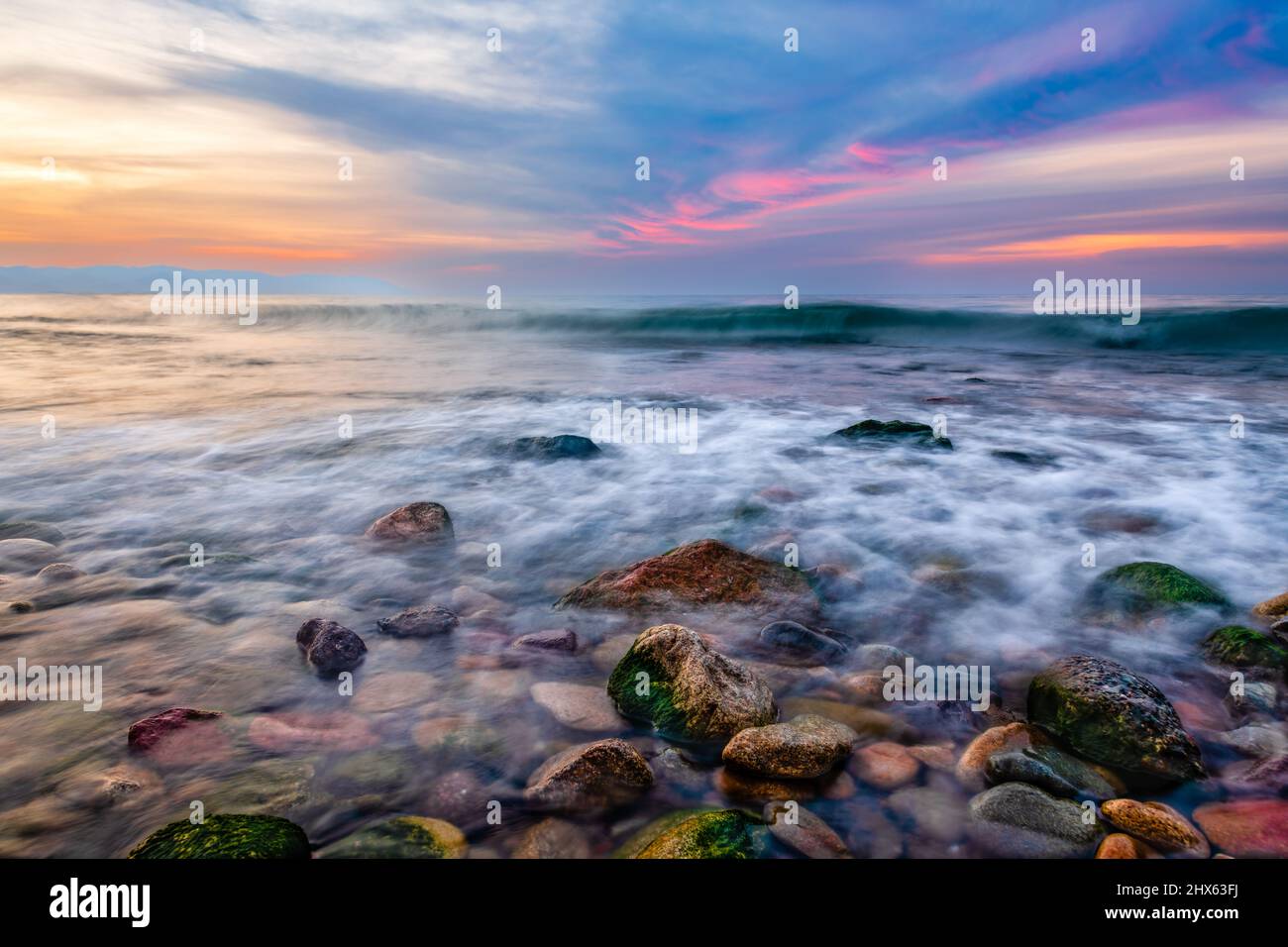 An Ocean Landscape With Sea rocks In The Foreground And A Colorful ...