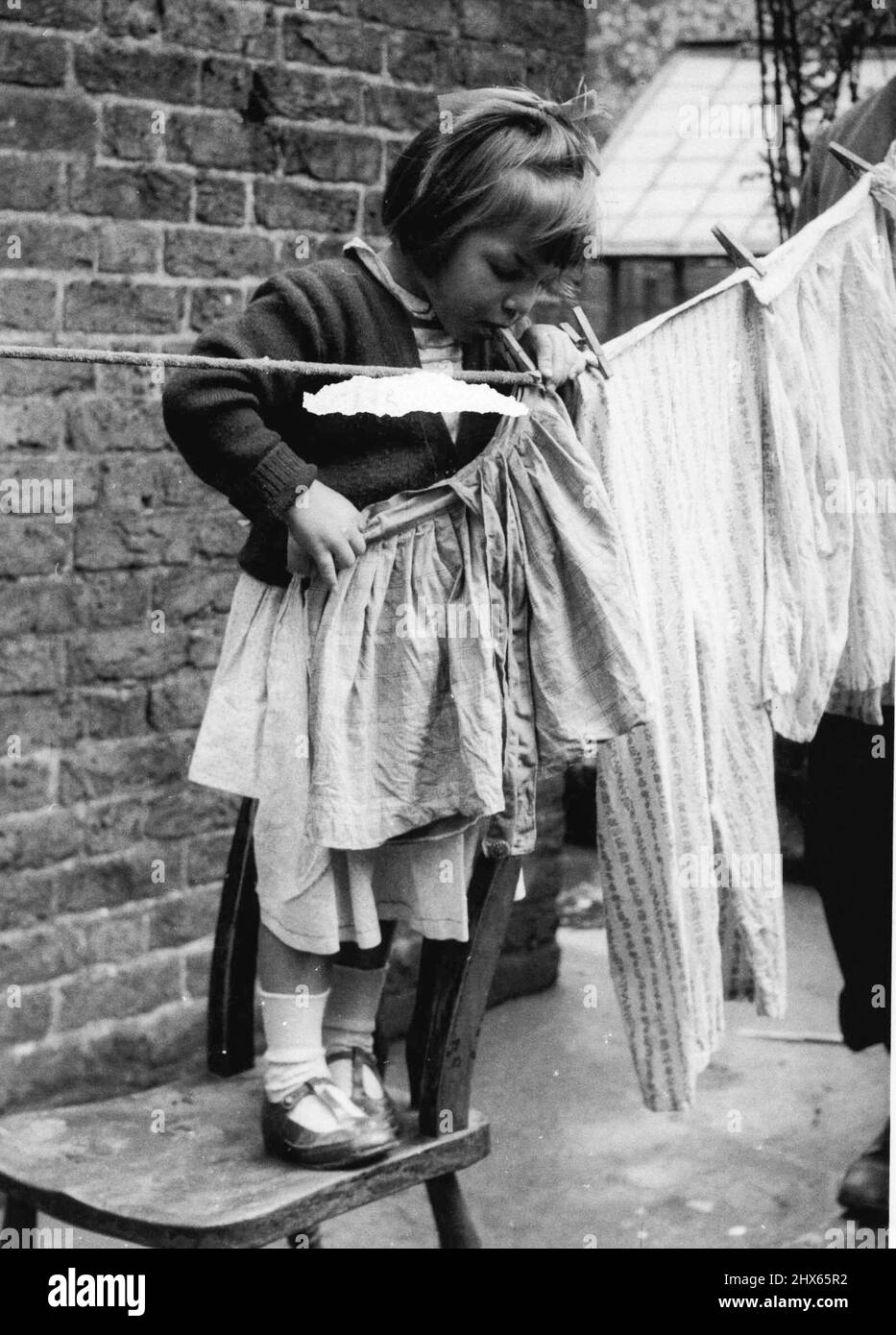 Pegs The Clothes Out - With Her Teeth -- Most children like to help ...