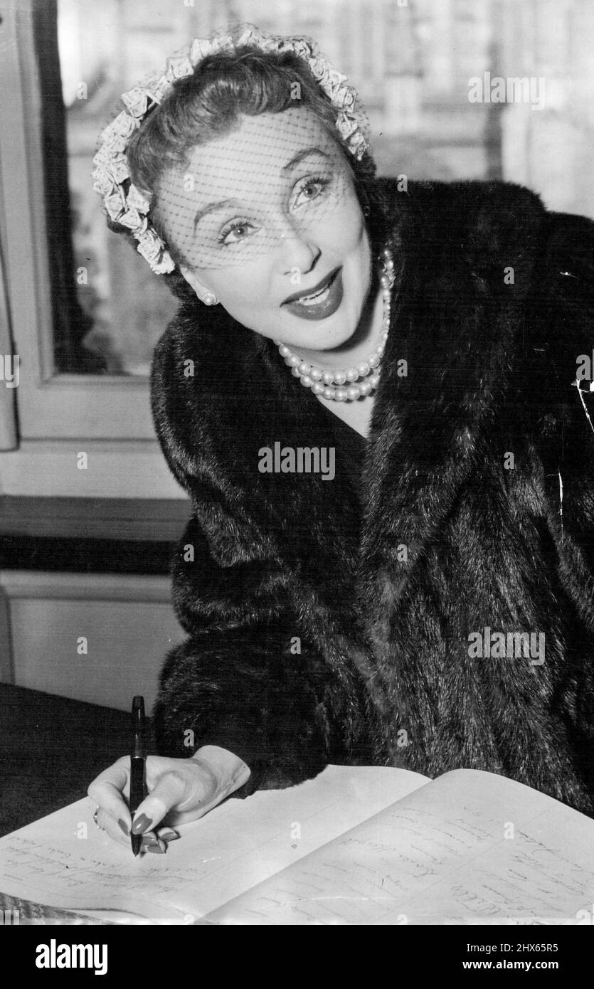 English actress Googie Withers signs the visitors' book at the Town ...