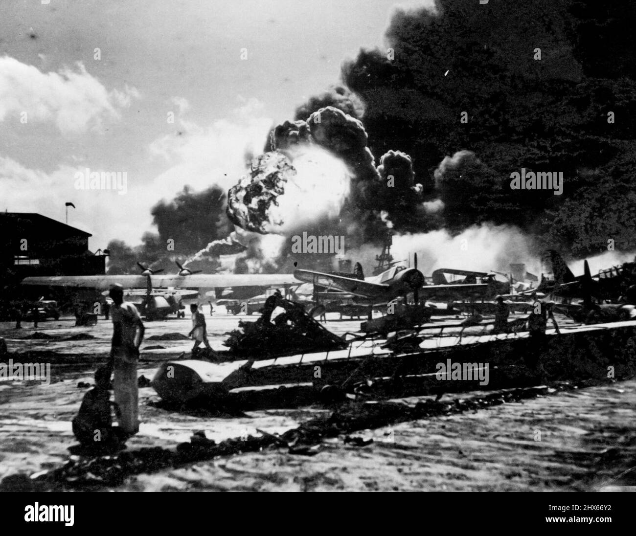 Against a background of smoke and flame, wreckage-strewn Naval Air ...