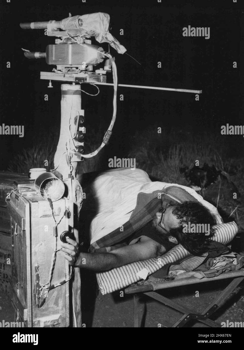 Daily News scientist-photographer W. Mangini on camp-stretcher beside ...
