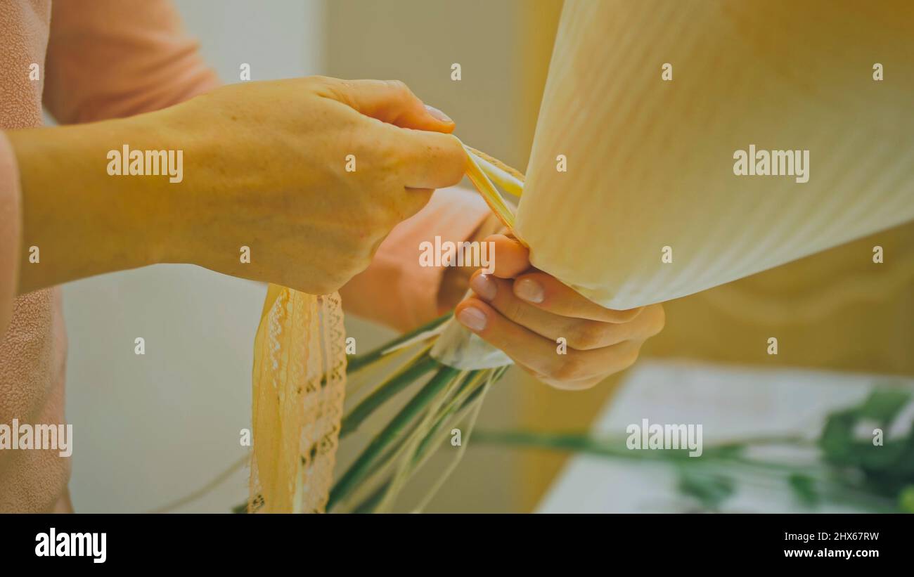 Professional florist cuts paper package hi-res stock photography and ...