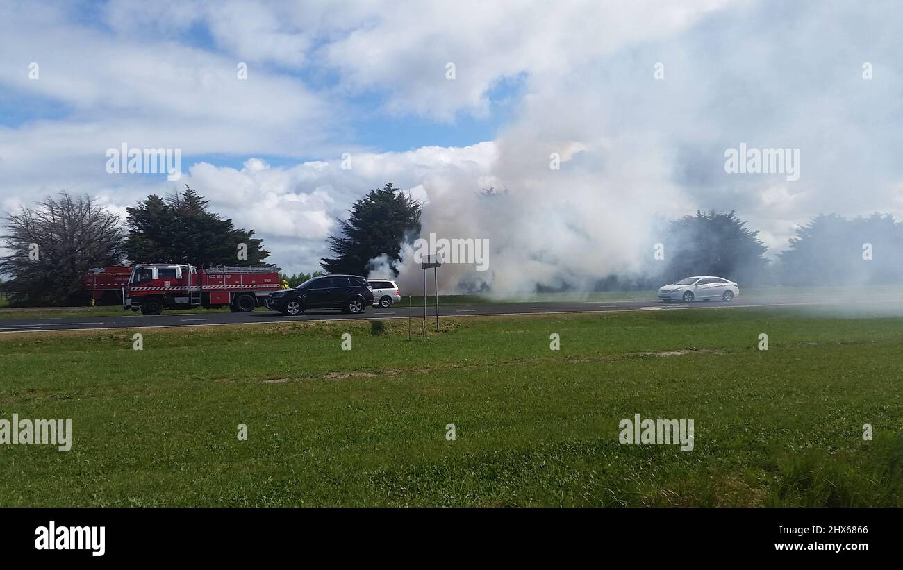 car on fire on side of road Stock Photo - Alamy
