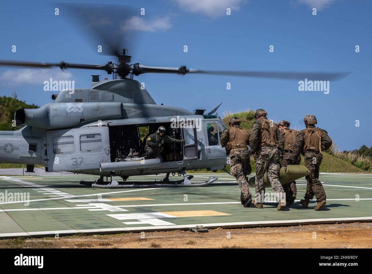 U.S. Marines with 3d Reconnaissance Battalion, 3d Marine Division, load ...