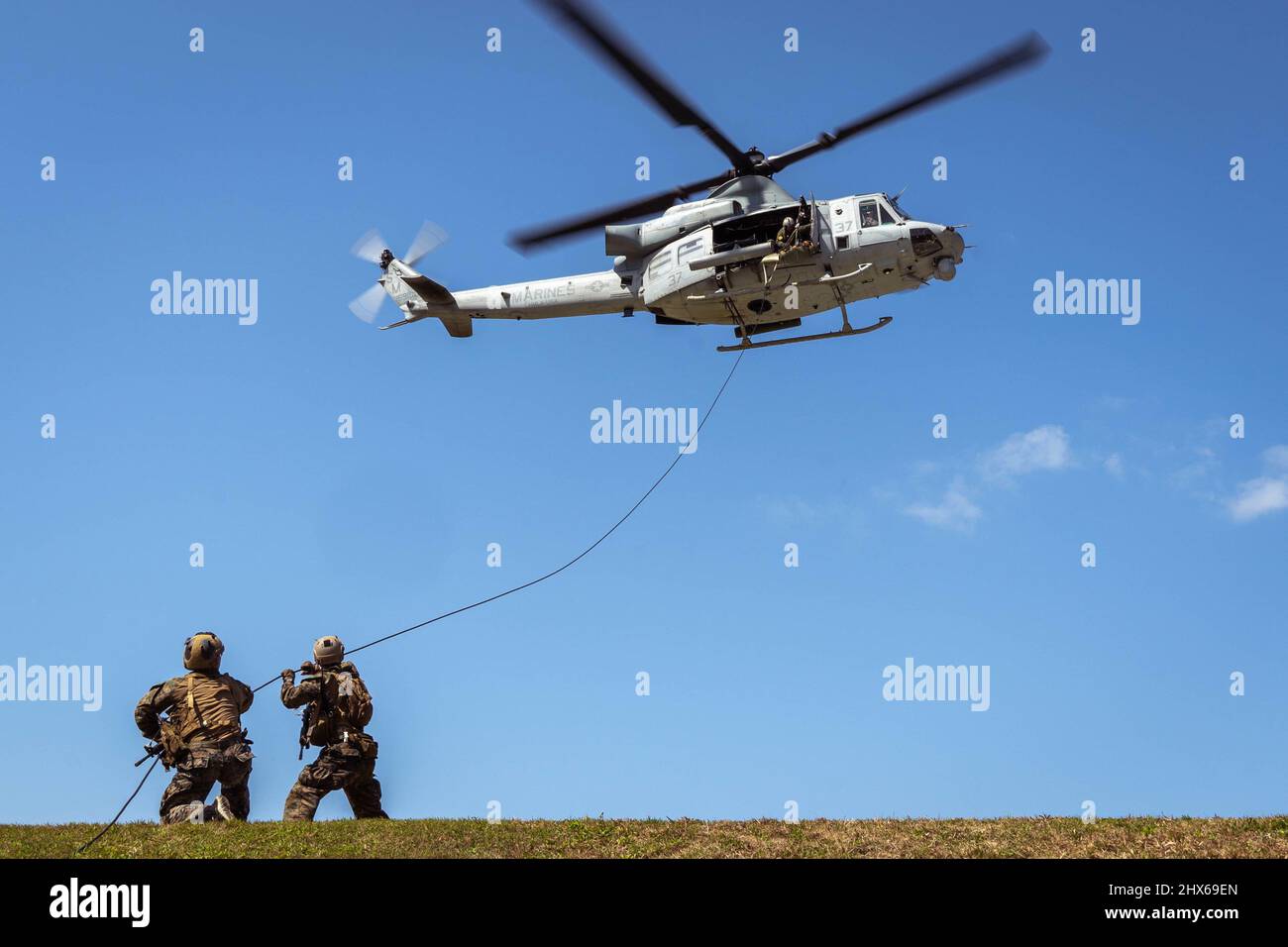 U.S. Marines with 3d Reconnaissance Battalion, 3d Marine Division, load ...