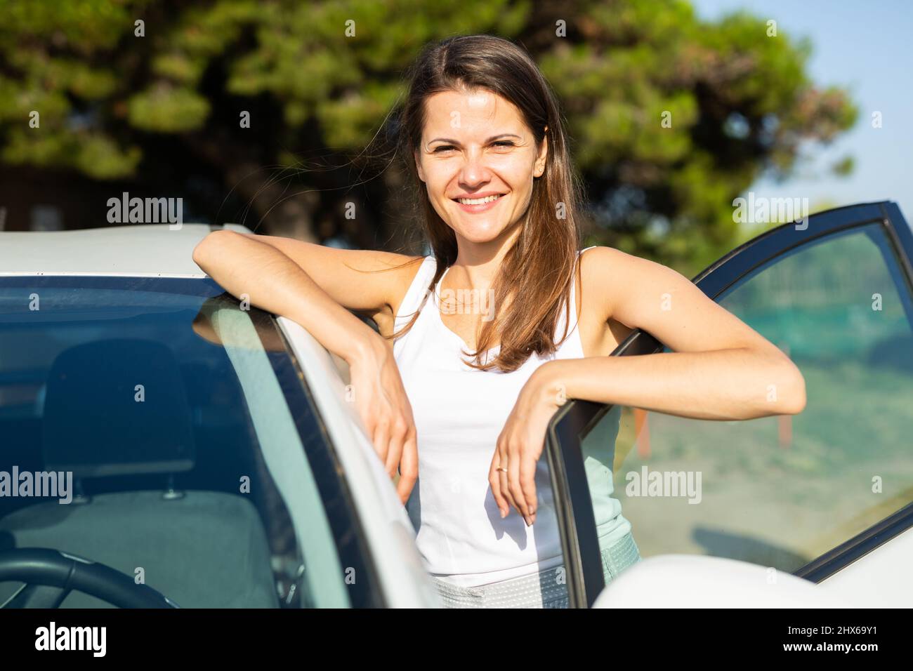Woman standing near car at sunny day Stock Photo - Alamy