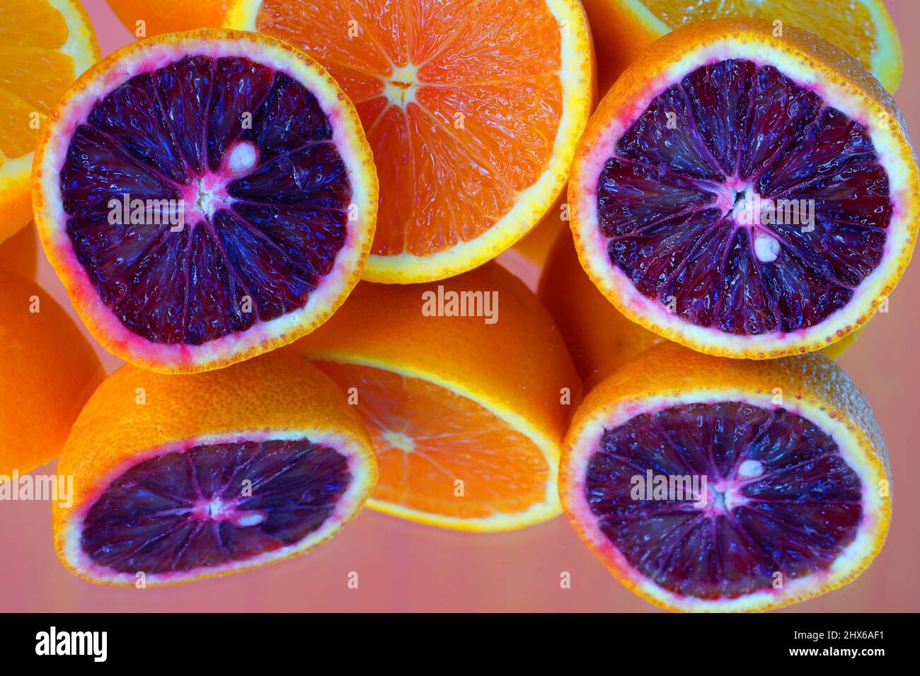 Colorful ruby red blood oranges, navel oranges, and clementines cut in ...