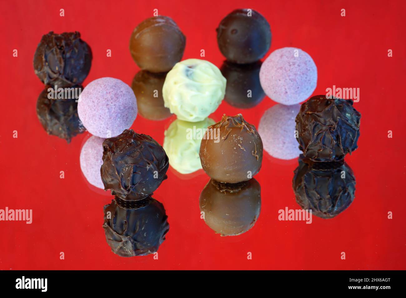 Colorful chocolate truffle confections reflecting on a mirror Stock ...