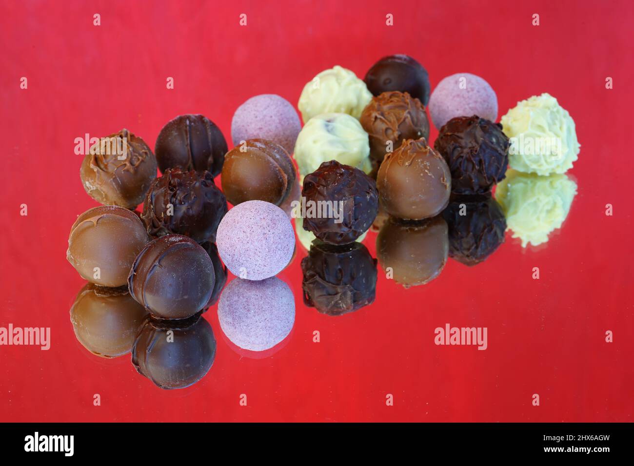 Colorful chocolate truffle confections reflecting on a mirror Stock ...