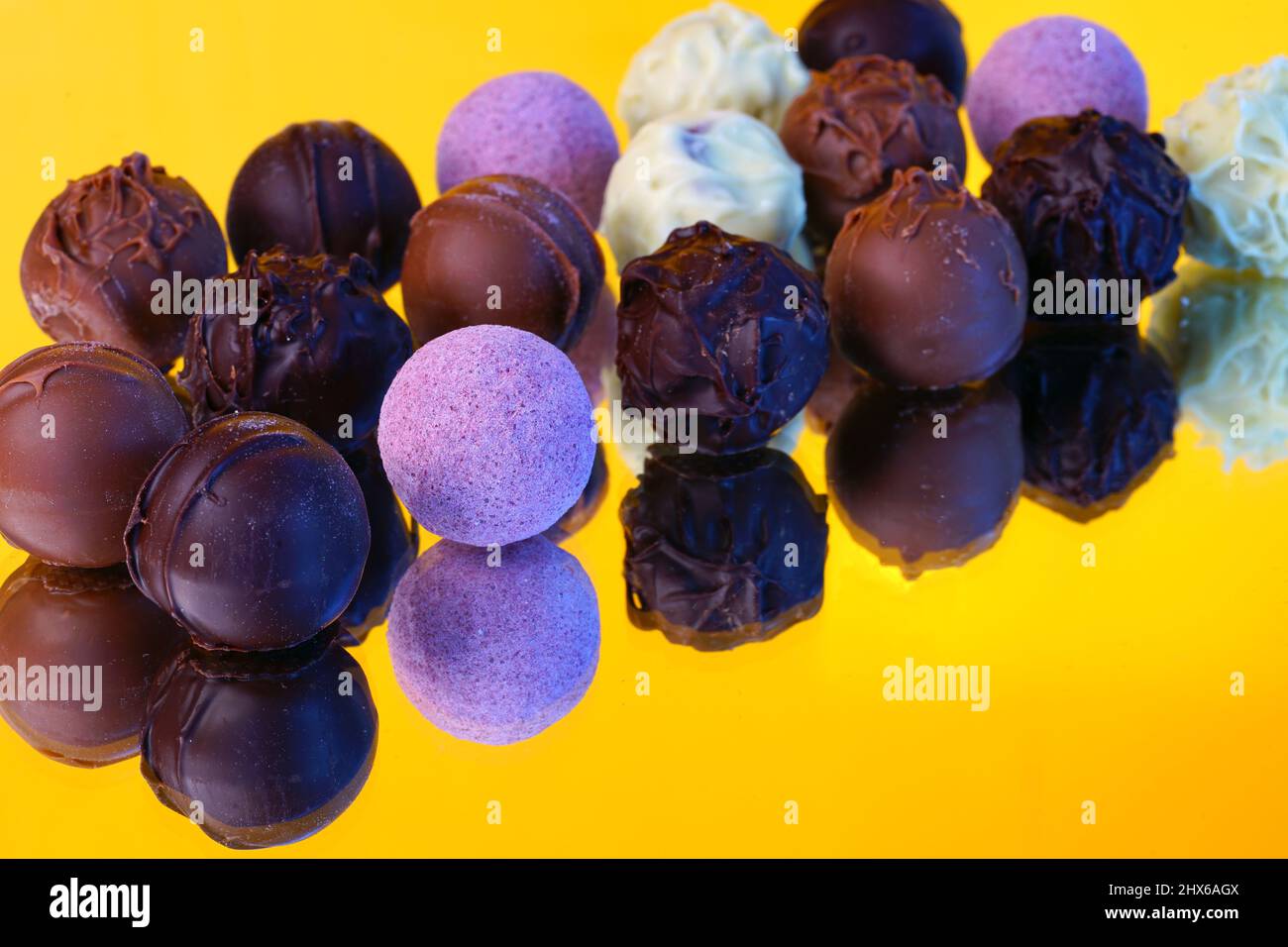 Colorful chocolate truffle confections reflecting on a mirror Stock ...