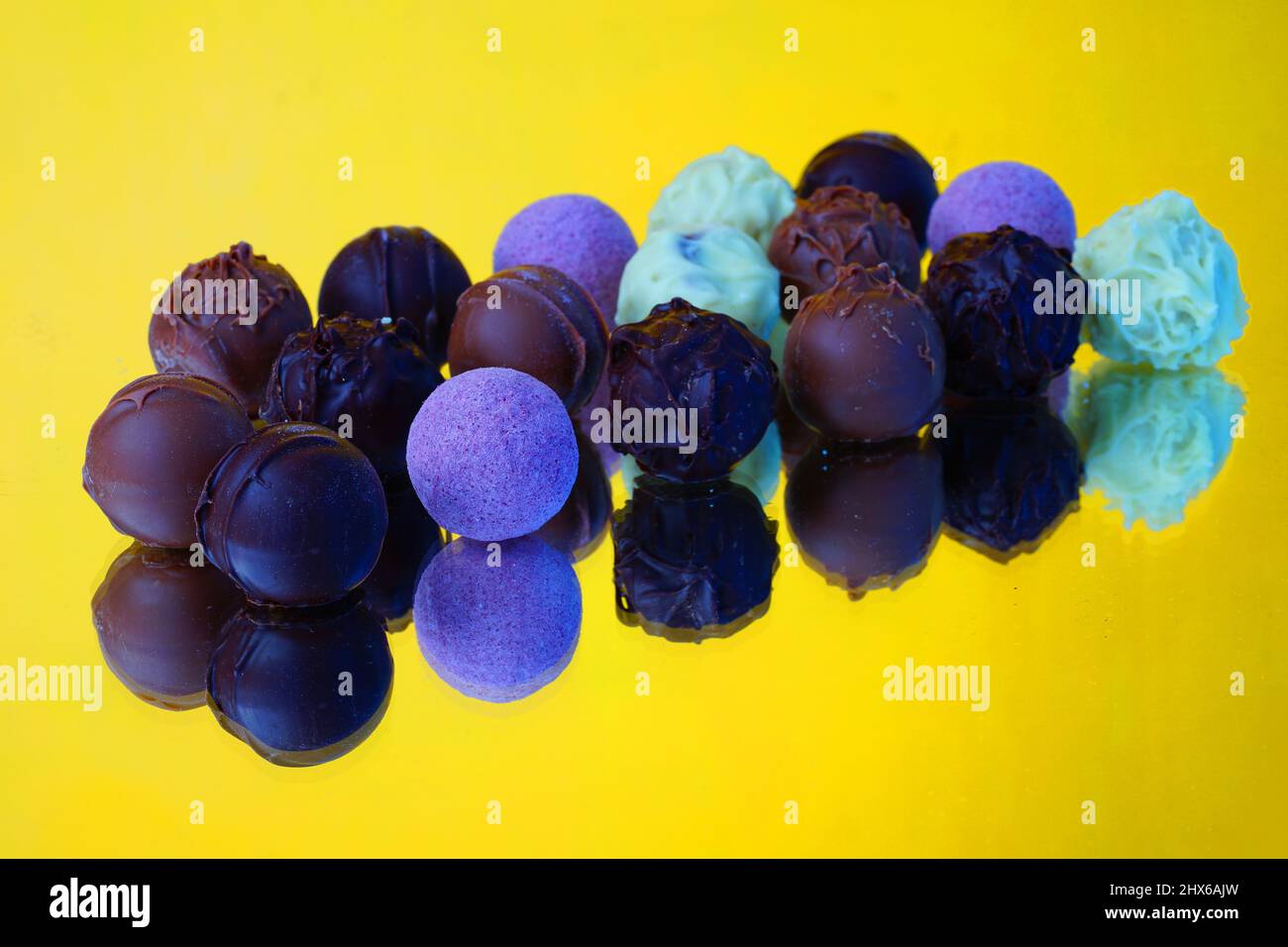 Colorful chocolate truffle confections reflecting on a mirror Stock ...
