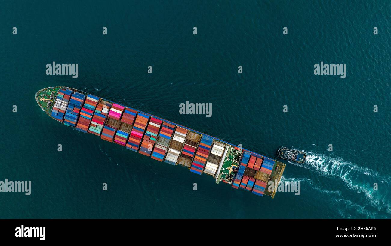 Aerial top view of cargo ship carrying container and running for export ...