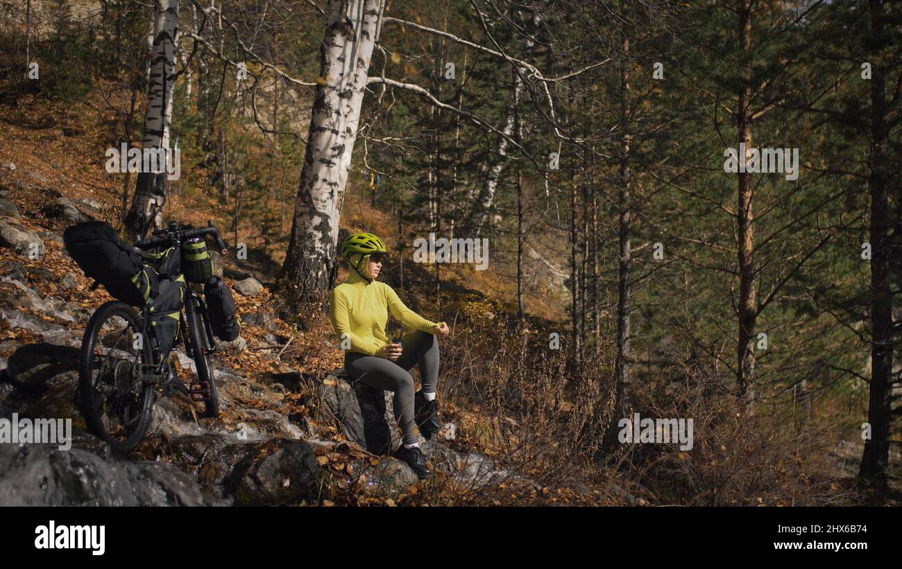 The woman travel on mixed terrain cycle touring with bikepacking. The ...