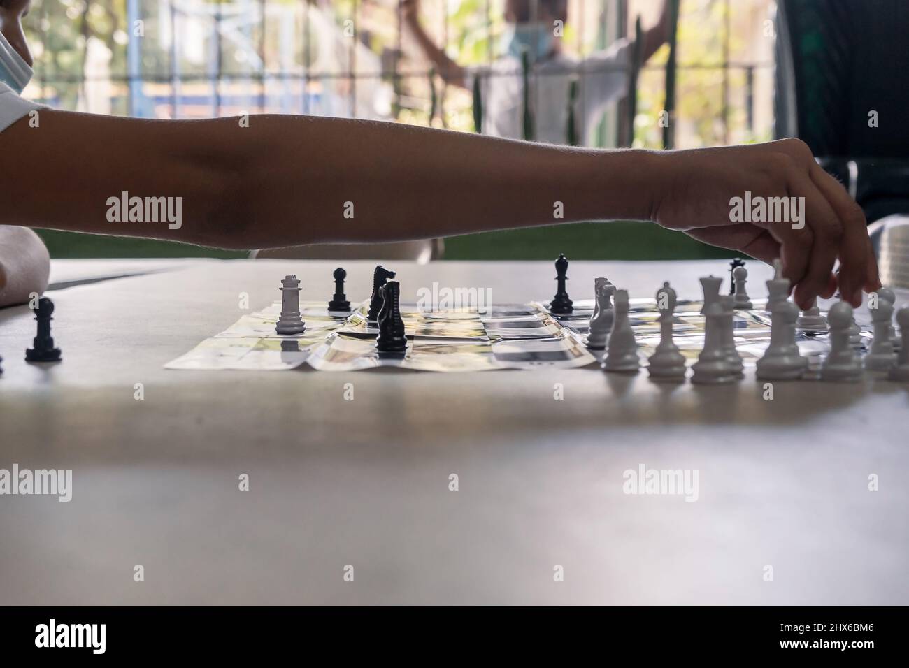 A girl makes her move in a game of chess against a boy in her classroom ...