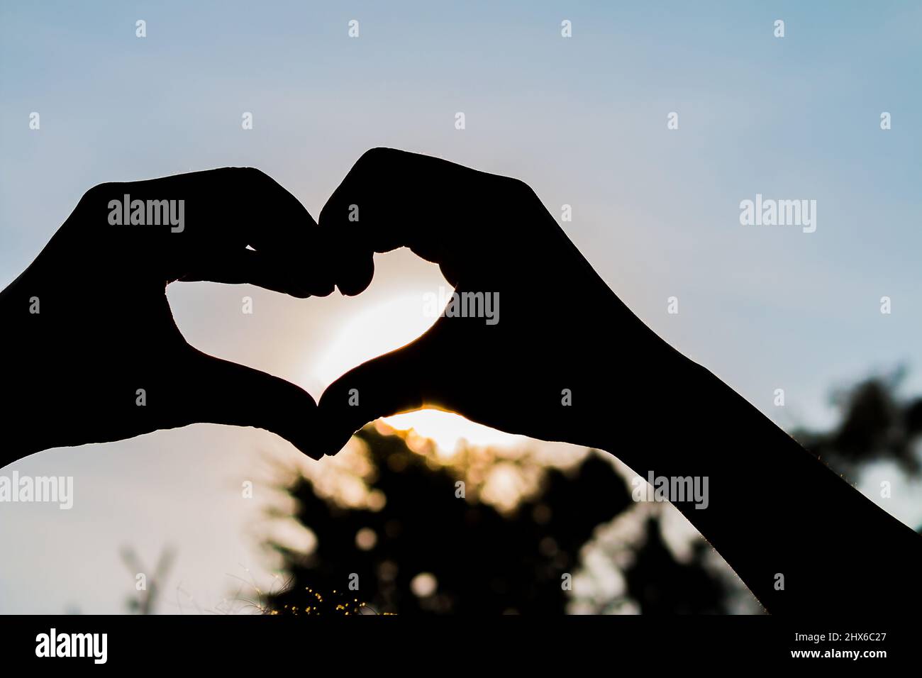 love shape hand silhouette at sunset background Stock Photo - Alamy