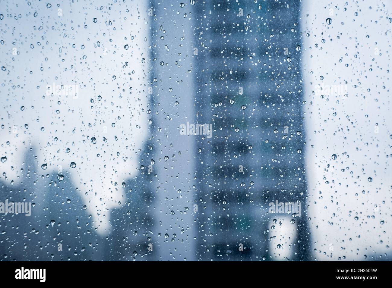 Abstract image of Rain drops on the dirty glass windows with modern ...