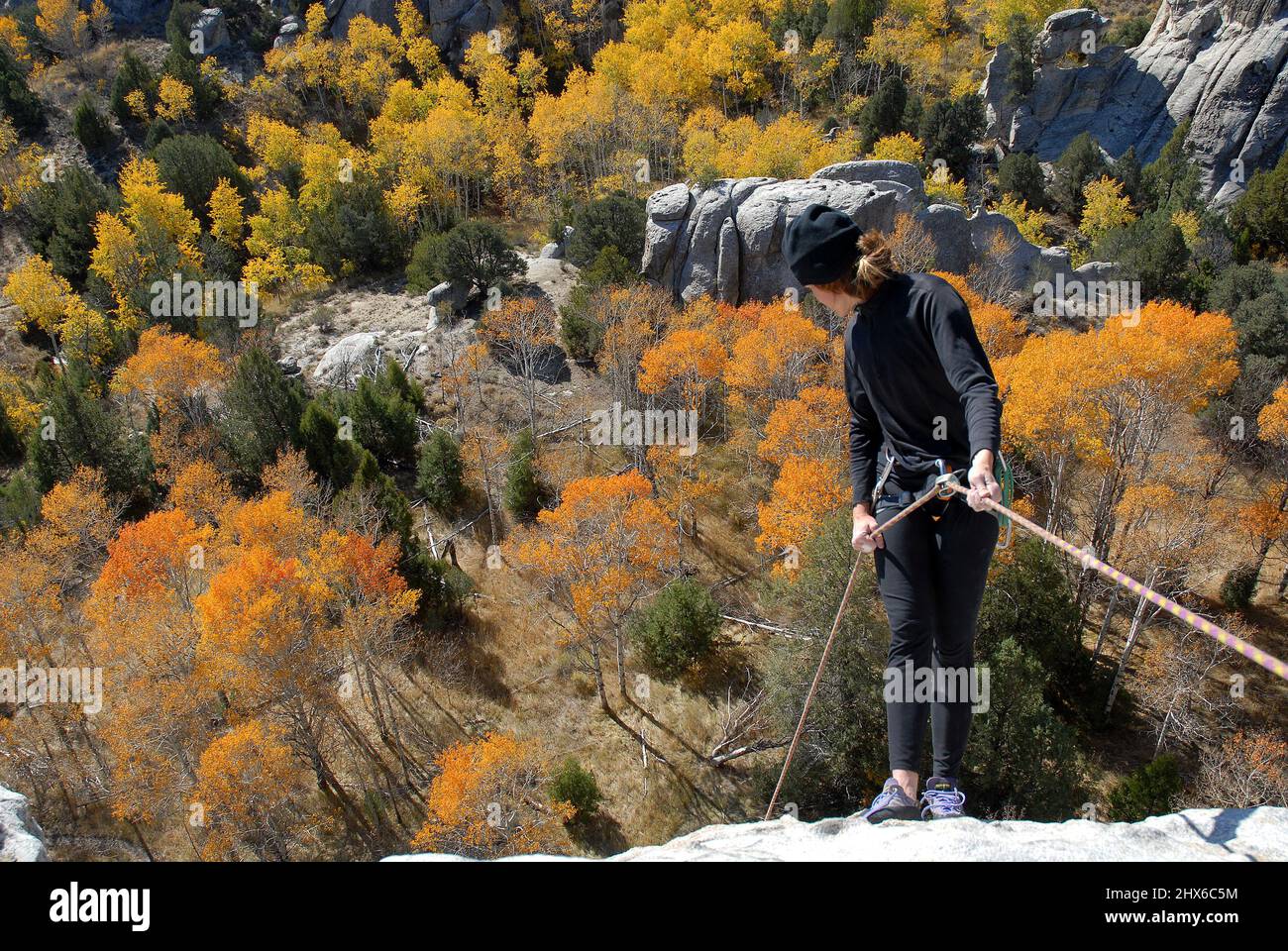 Single woman rock climber scales vertical cliff at City of Rock, Idaho ...