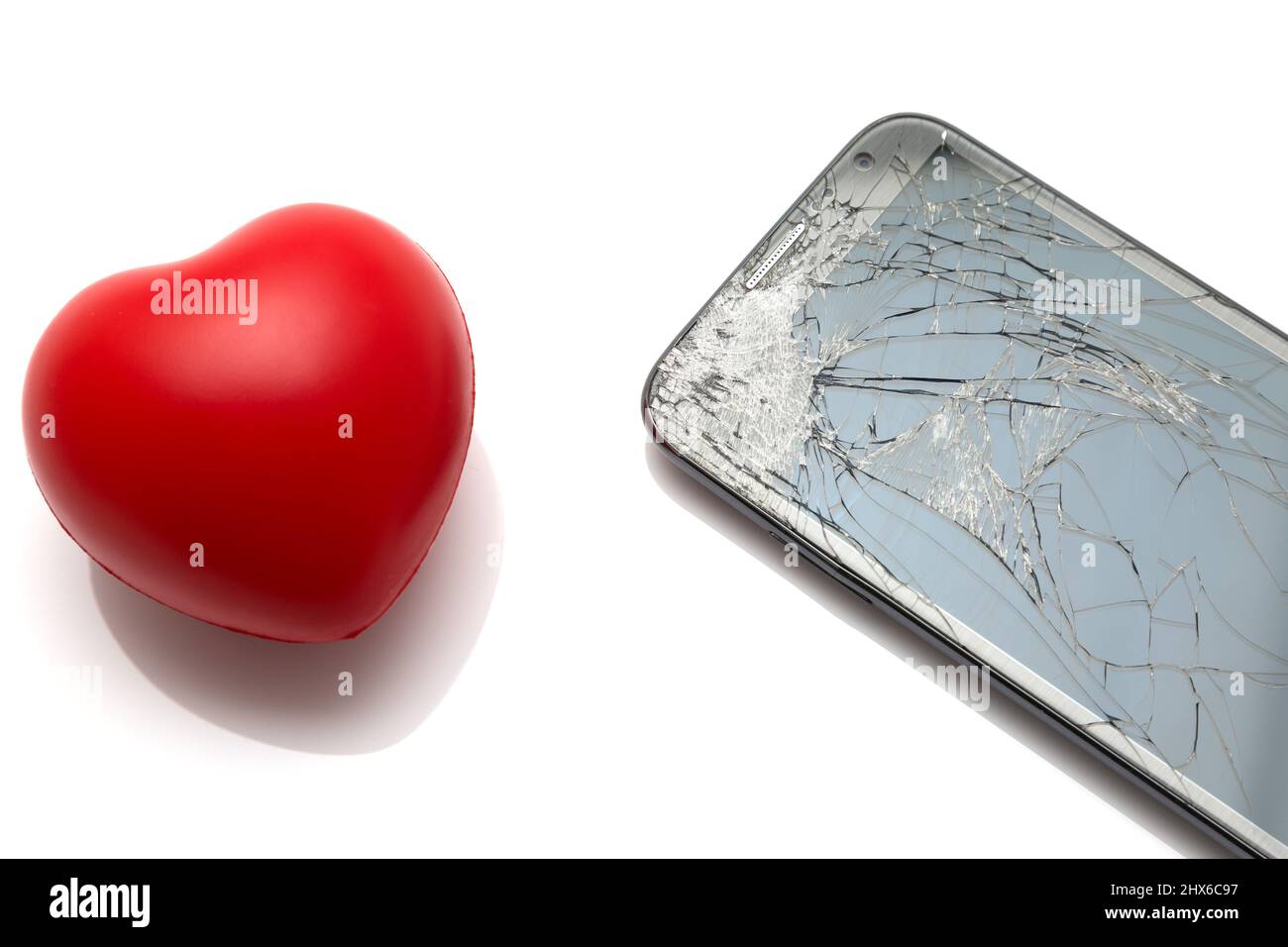 Smartphone with broken screen with red heart isolated on white ...