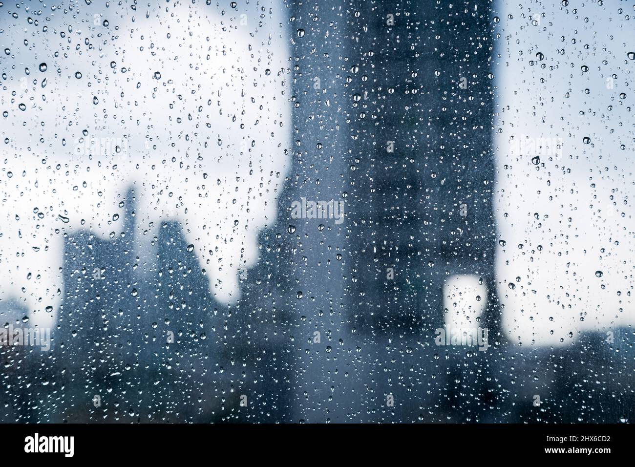 Abstract image of Rain drops on the dirty glass windows with modern ...