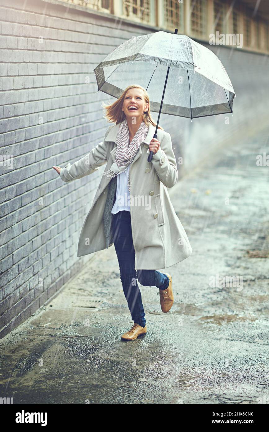 The rain never bothered her anyway. Full length shot of an attractive ...