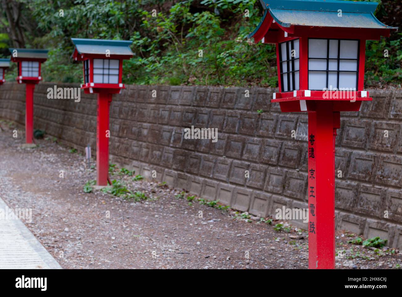 Vermillion lanterns line the main path on the holy mountain of Takao ...