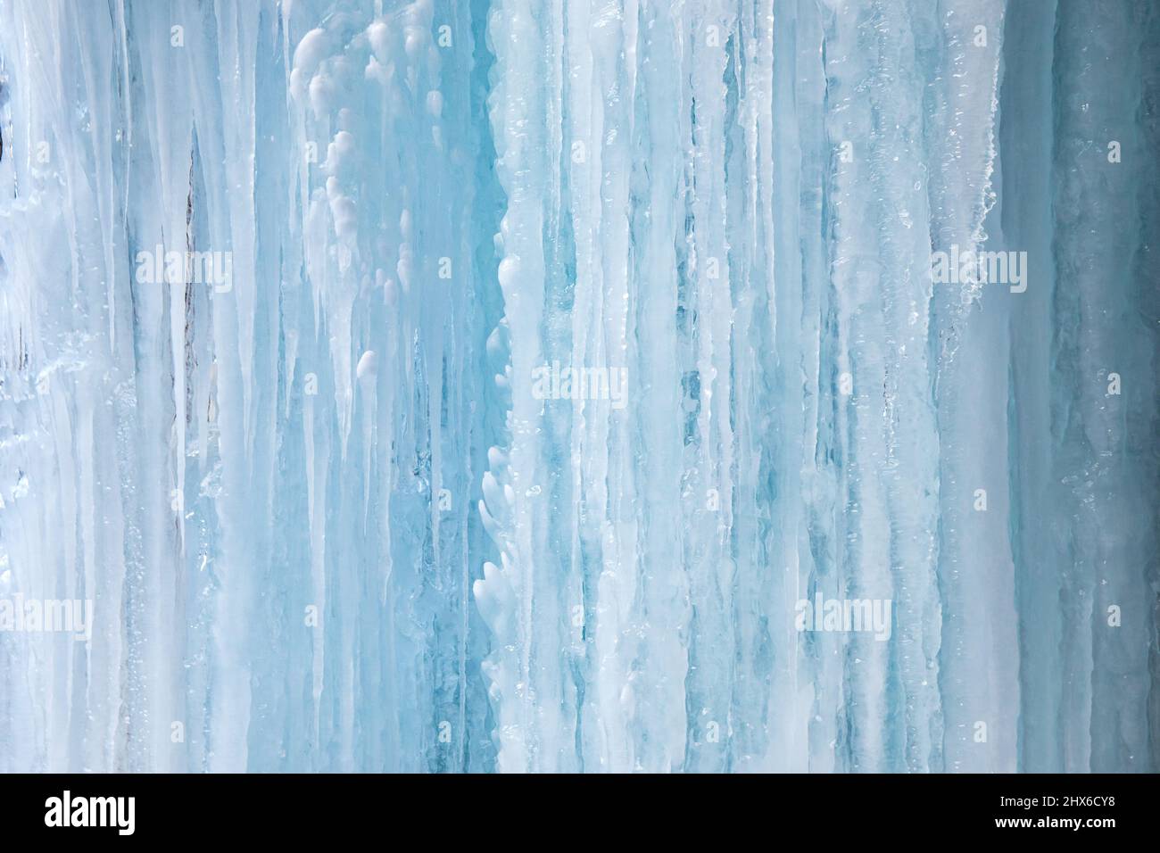 Icy, frozen textured icicle wall for background Stock Photo - Alamy