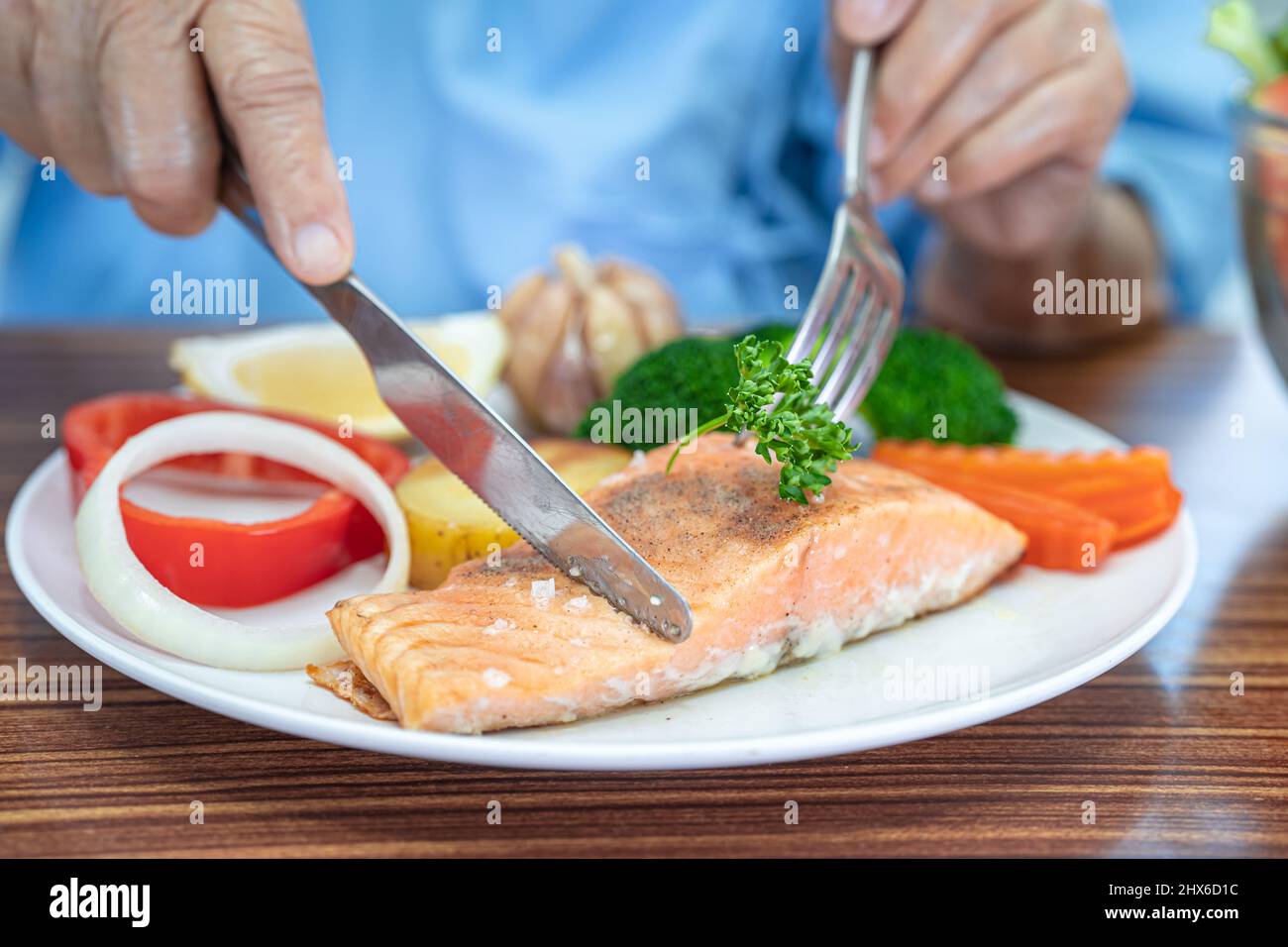 Asian senior or elderly old lady woman patient eating Salmon steak ...