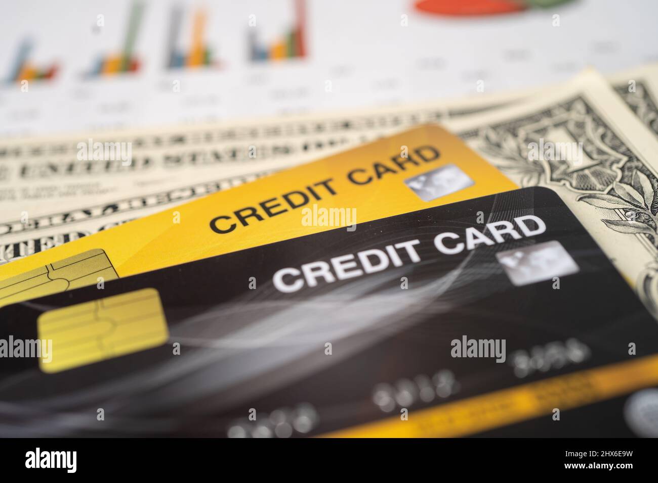 Credit card with US dollar banknote on chart and graph paper. Finance ...