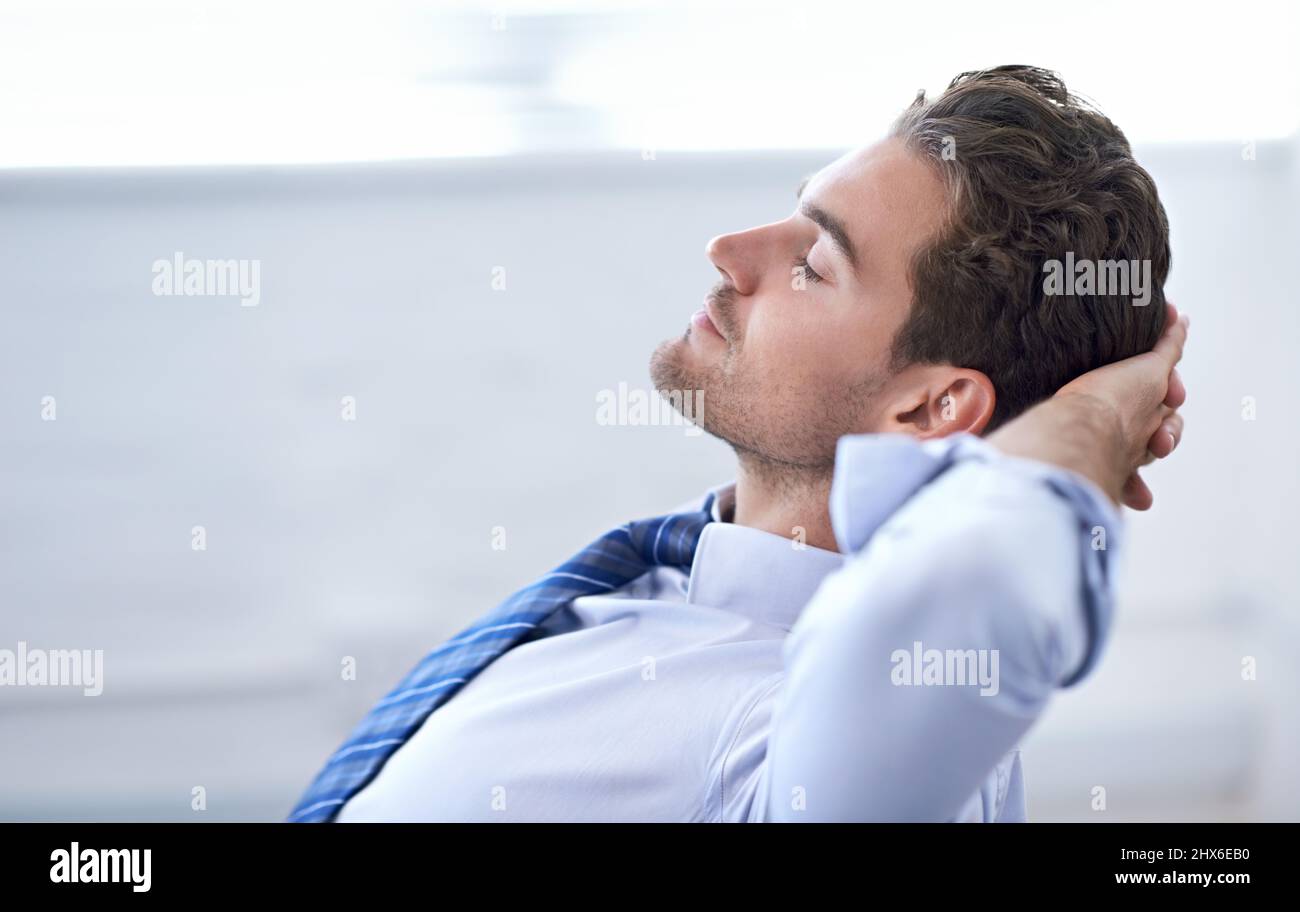 Siesta at the office. A young businessman taking a break at the office ...